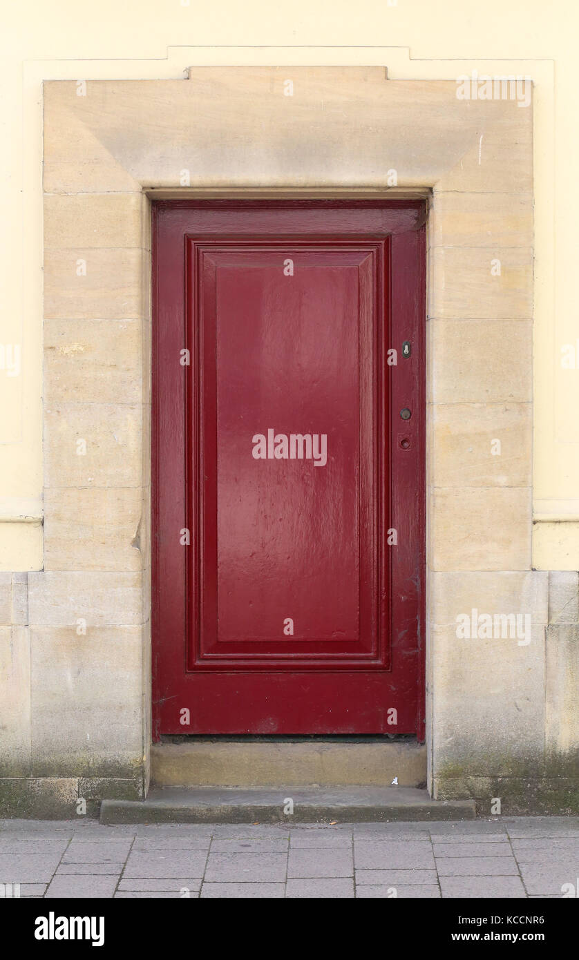 Abandoned dark red front door on the stone wall, street pavement Stock ...