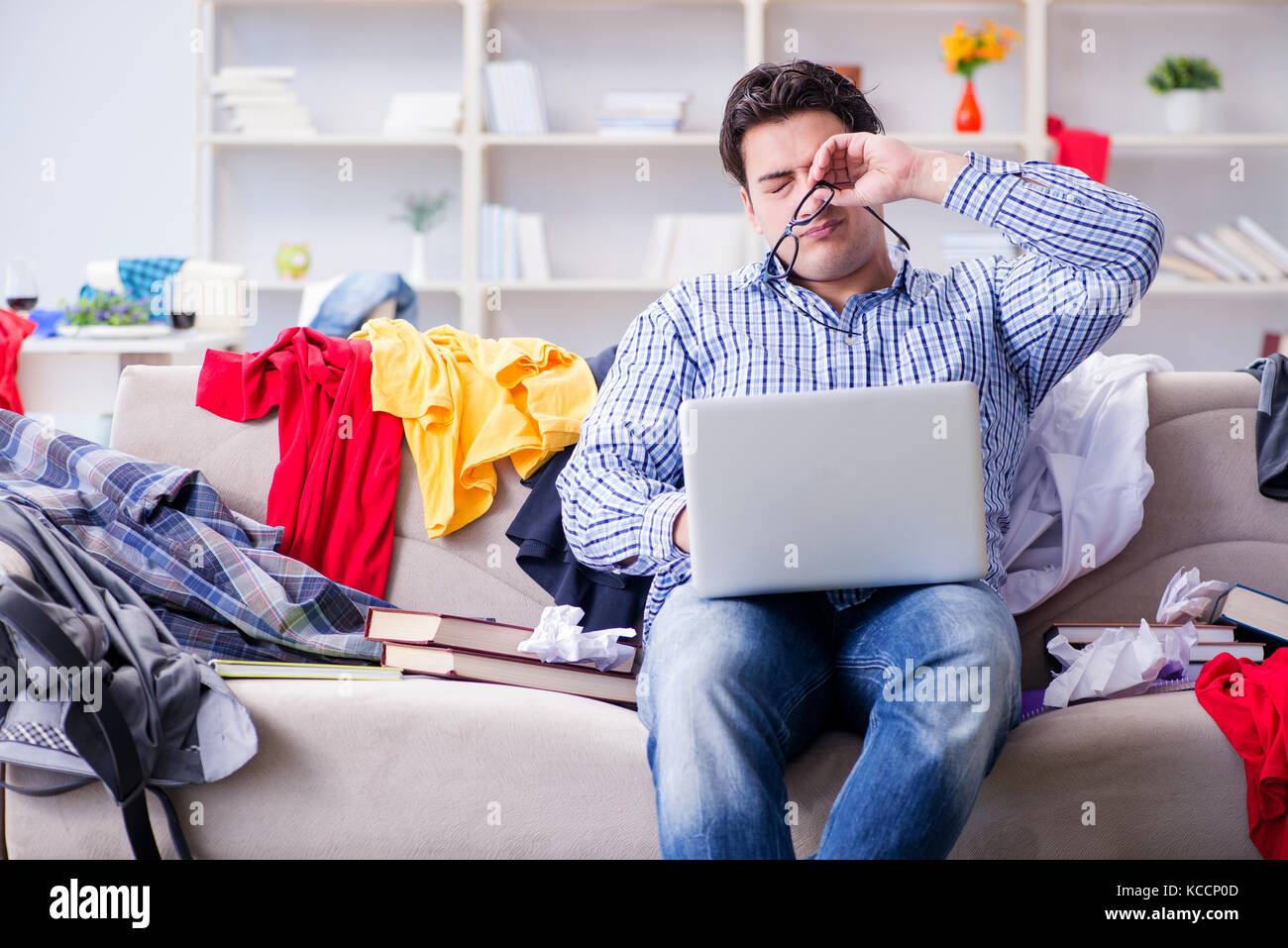 Young man working studying in messy room Stock Photo - Alamy
