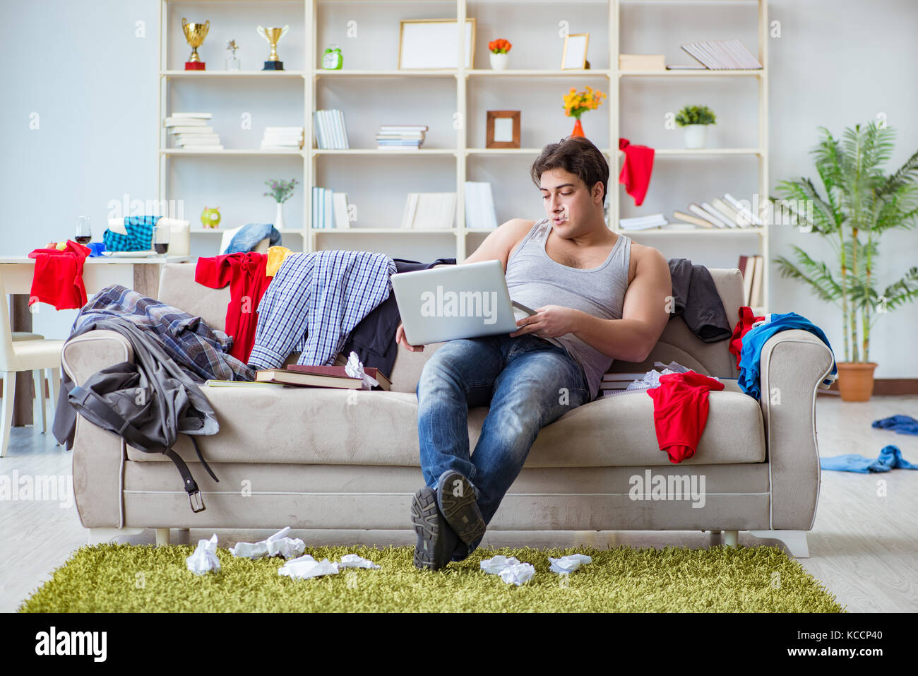 Young man working studying in messy room Stock Photo - Alamy