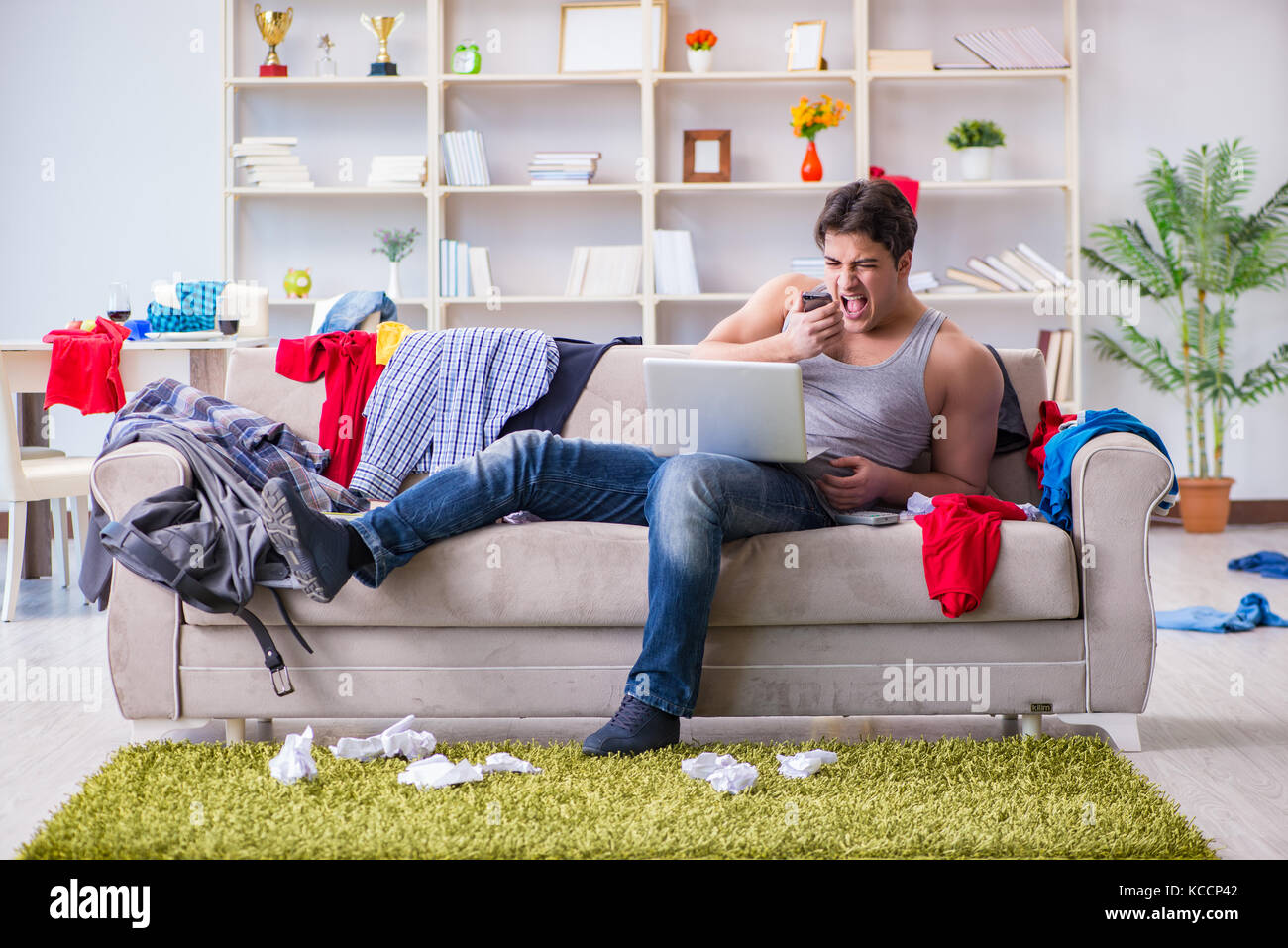 Young man working studying in messy room Stock Photo - Alamy