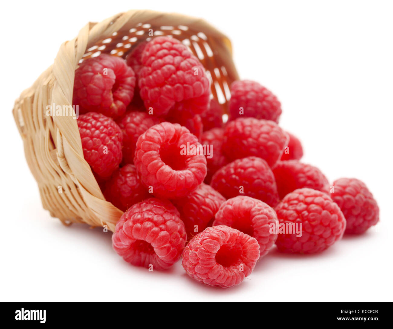 Fresh Raspberries in a wooden basket over white background Stock Photo ...
