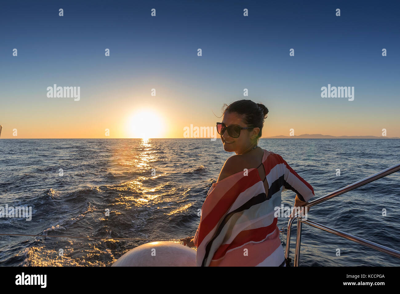SANTORINI/GREECE 04 SEP 2017 - Young girl at the bow of boat with ...