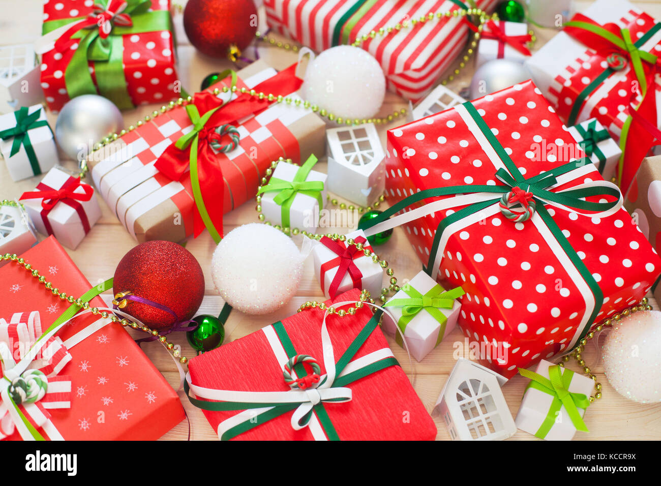 Christmas presents in red packaging. Satin colored ribbons. Background ...