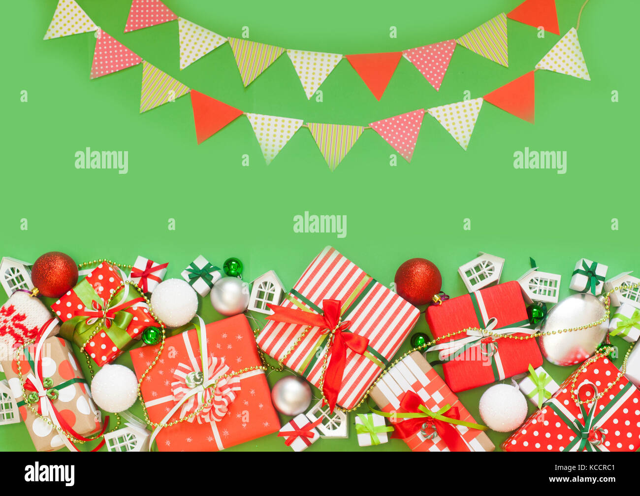 Christmas presents in red packaging. Satin colored ribbons. Green ...