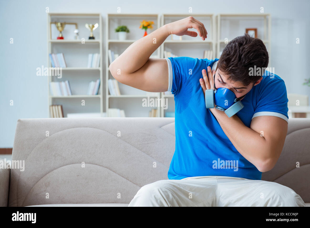 Man sweating excessively smelling bad at home Stock Photo - Alamy