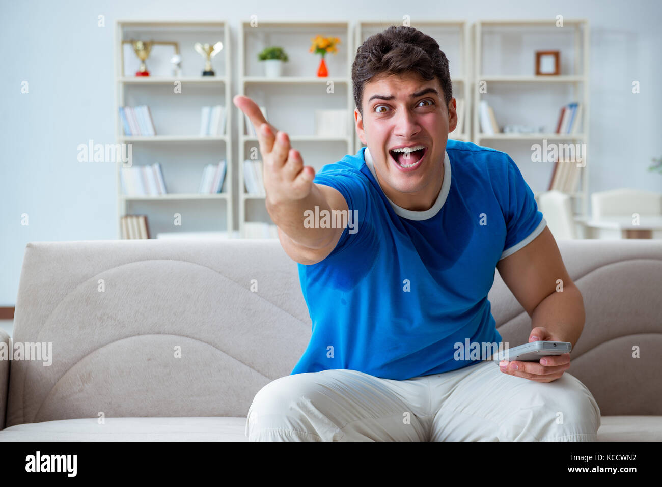 Man sweating excessively smelling bad at home Stock Photo - Alamy