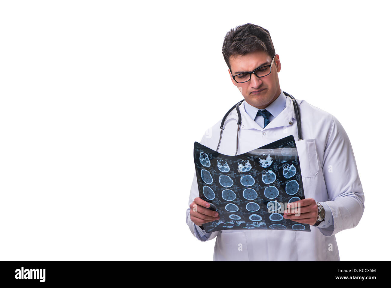 Young male doctor holding a radiograph isolated on white background ...