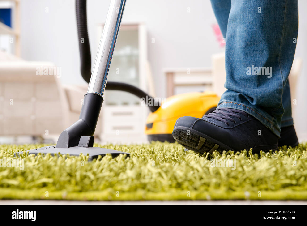 Man cleaning the floor carpet with a vacuum cleaner close up Stock ...