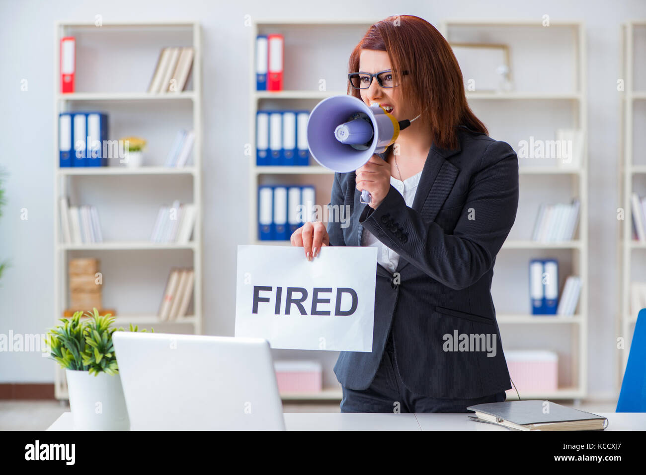 Businesswoman firing people in office Stock Photo - Alamy