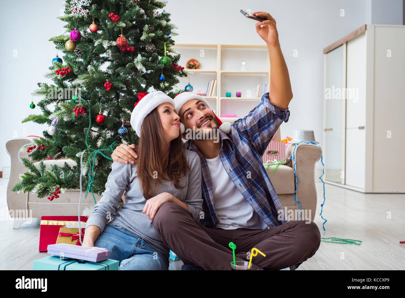 Young pair taking selfies during christmas Stock Photo - Alamy