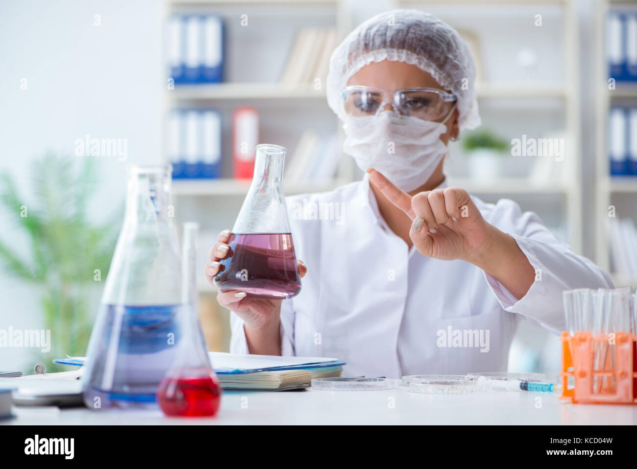 Female scientist researcher conducting an experiment in a laboratory ...
