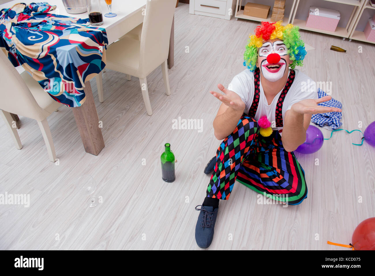 Drunk clown celebrating having a party at home Stock Photo - Alamy