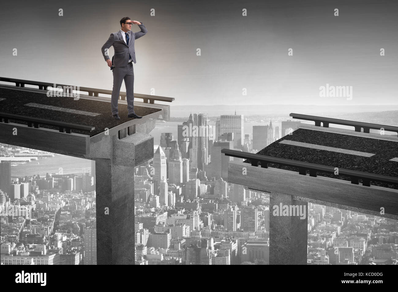 Businessman ready to overcome the broken bridge Stock Photo - Alamy
