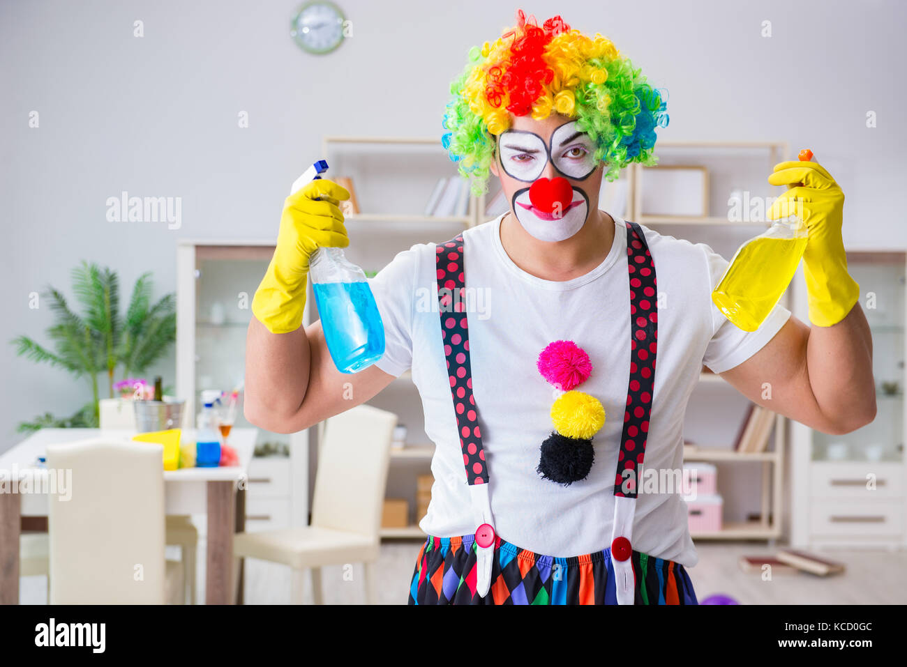 Funny clown doing cleaning at home Stock Photo - Alamy