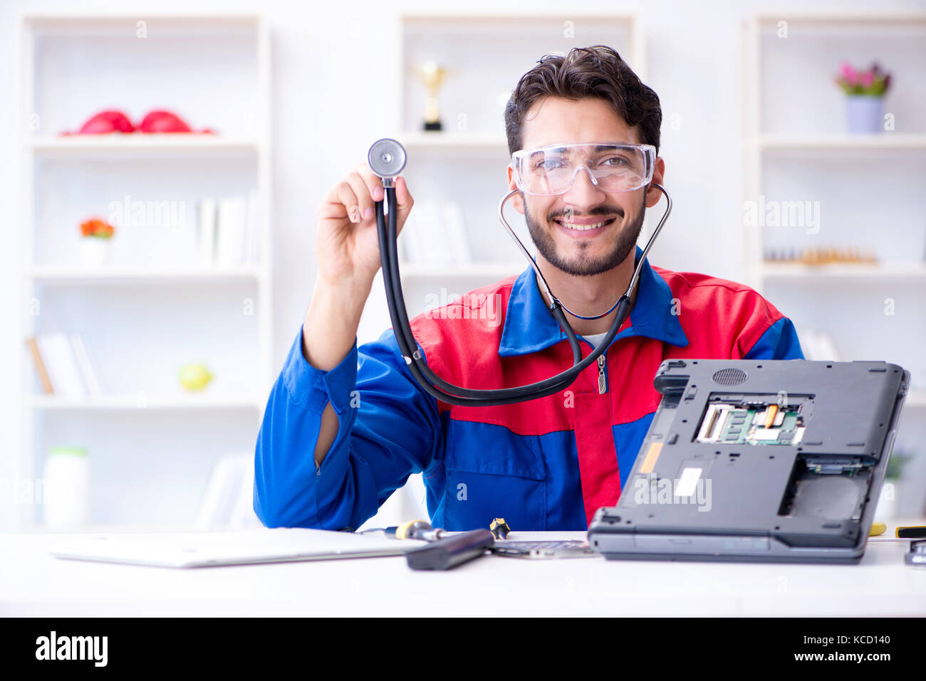 Repairman working in technical support fixing computer laptop ...