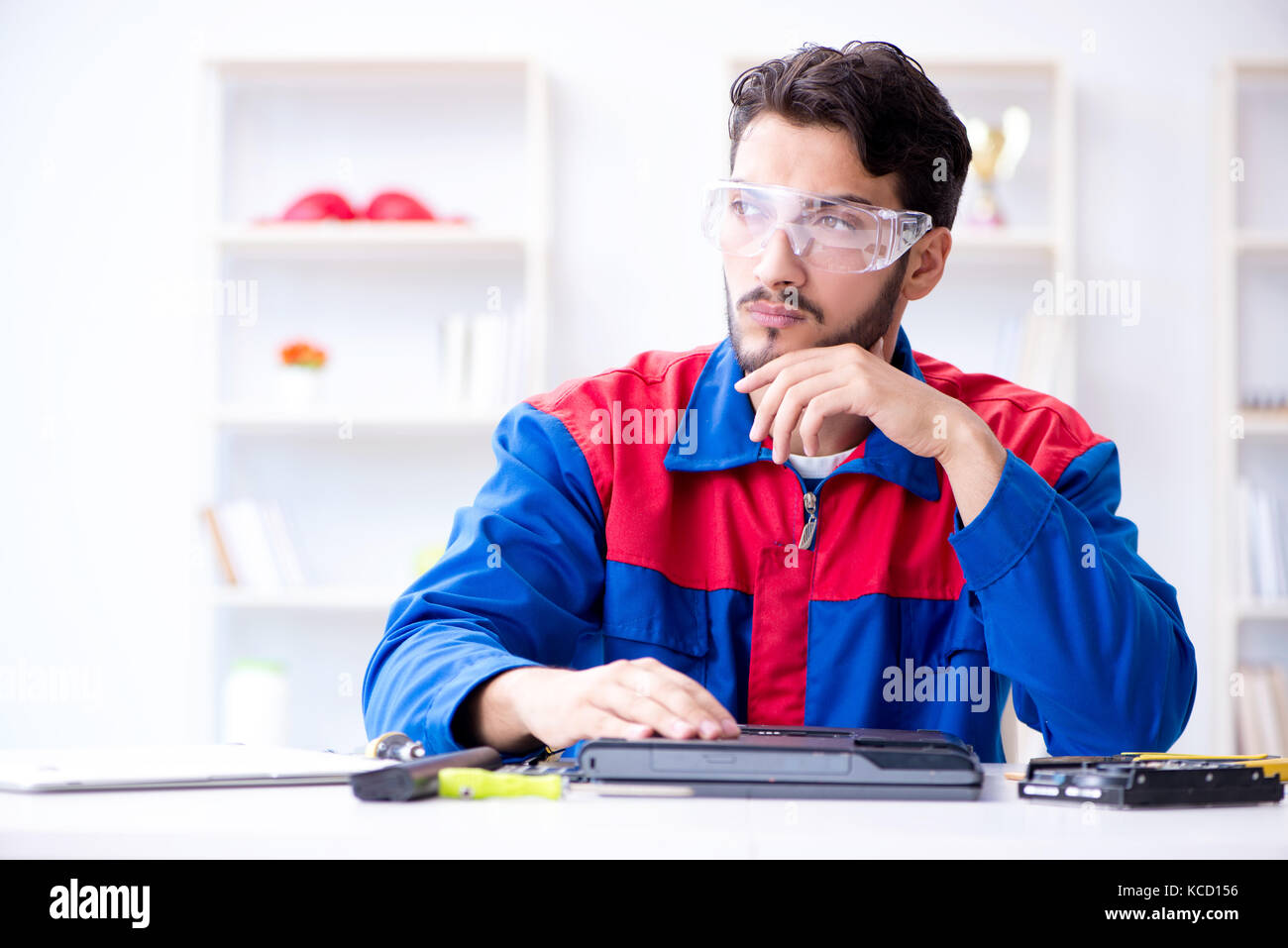 Repairman working in technical support fixing computer laptop ...