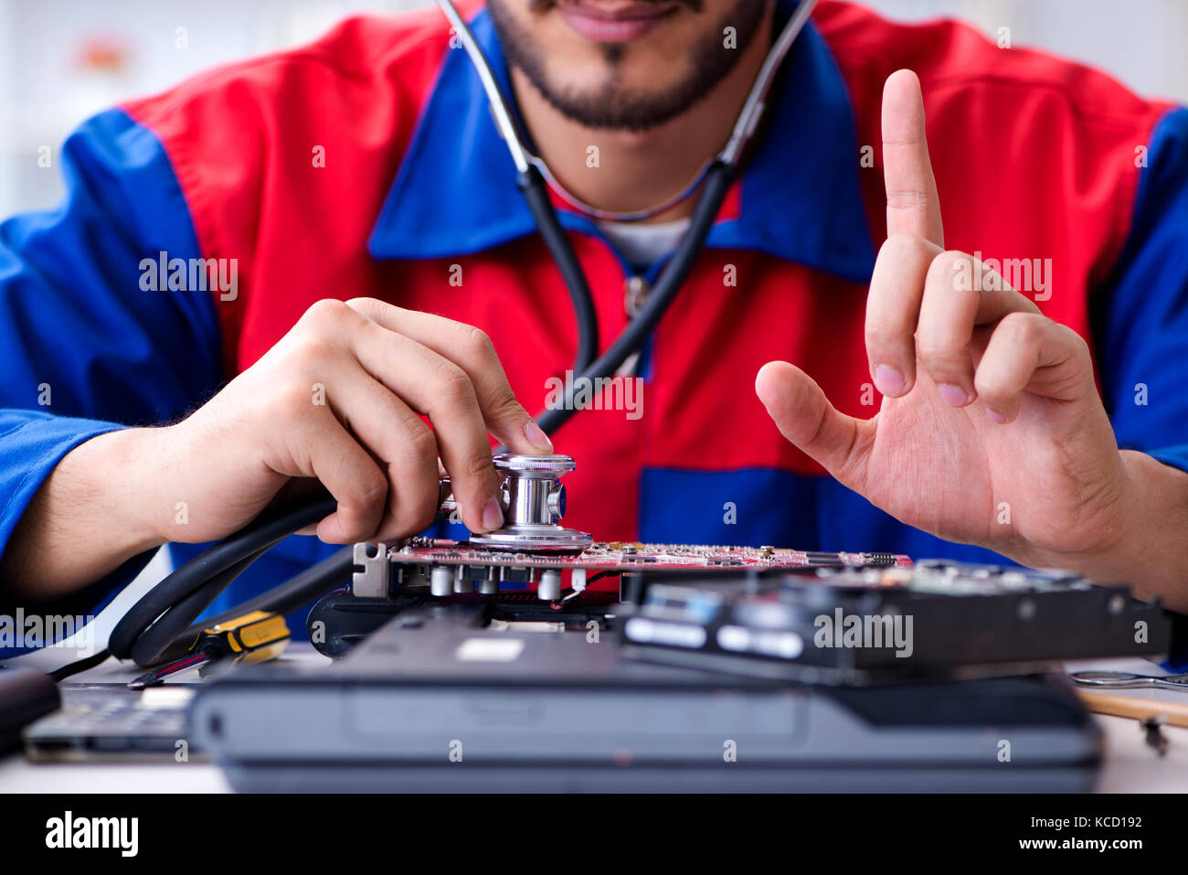 Repairman working in technical support fixing computer laptop ...