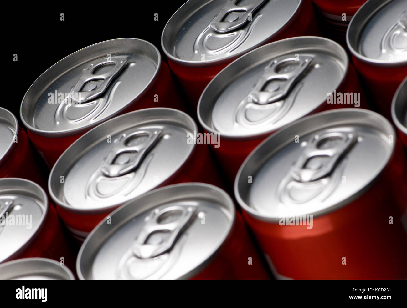 group of red can tins close up on a black background Stock Photo - Alamy