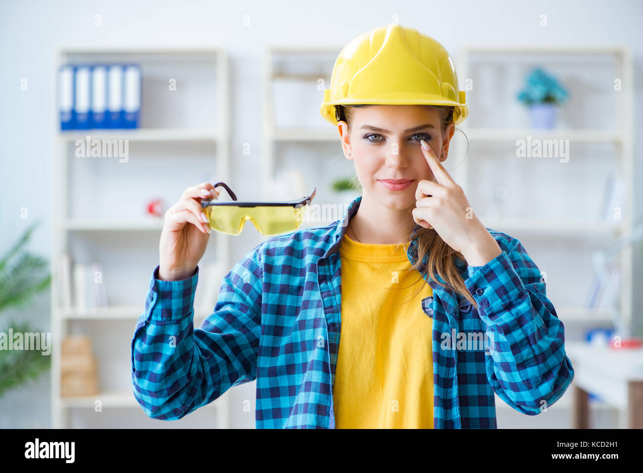 Woman in workshop with protective goggles Stock Photo - Alamy
