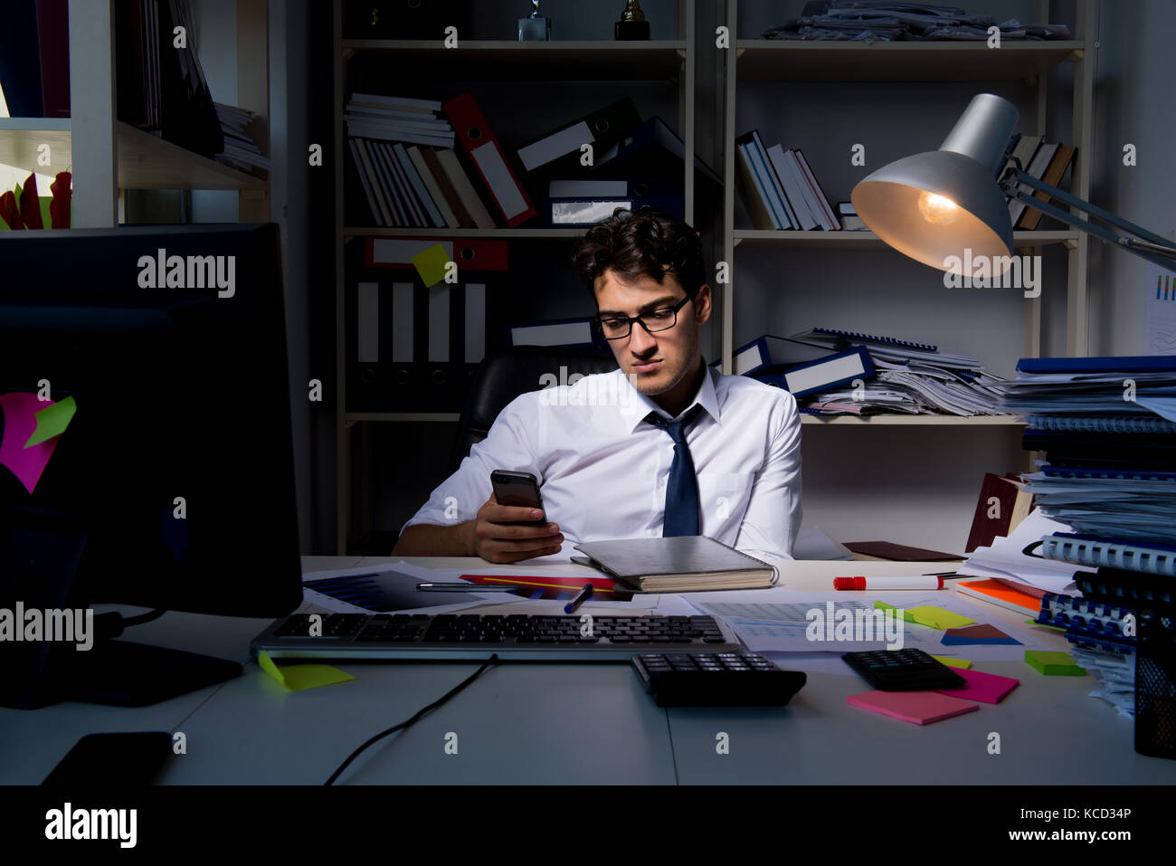 Man businessman working late hours in the office Stock Photo - Alamy