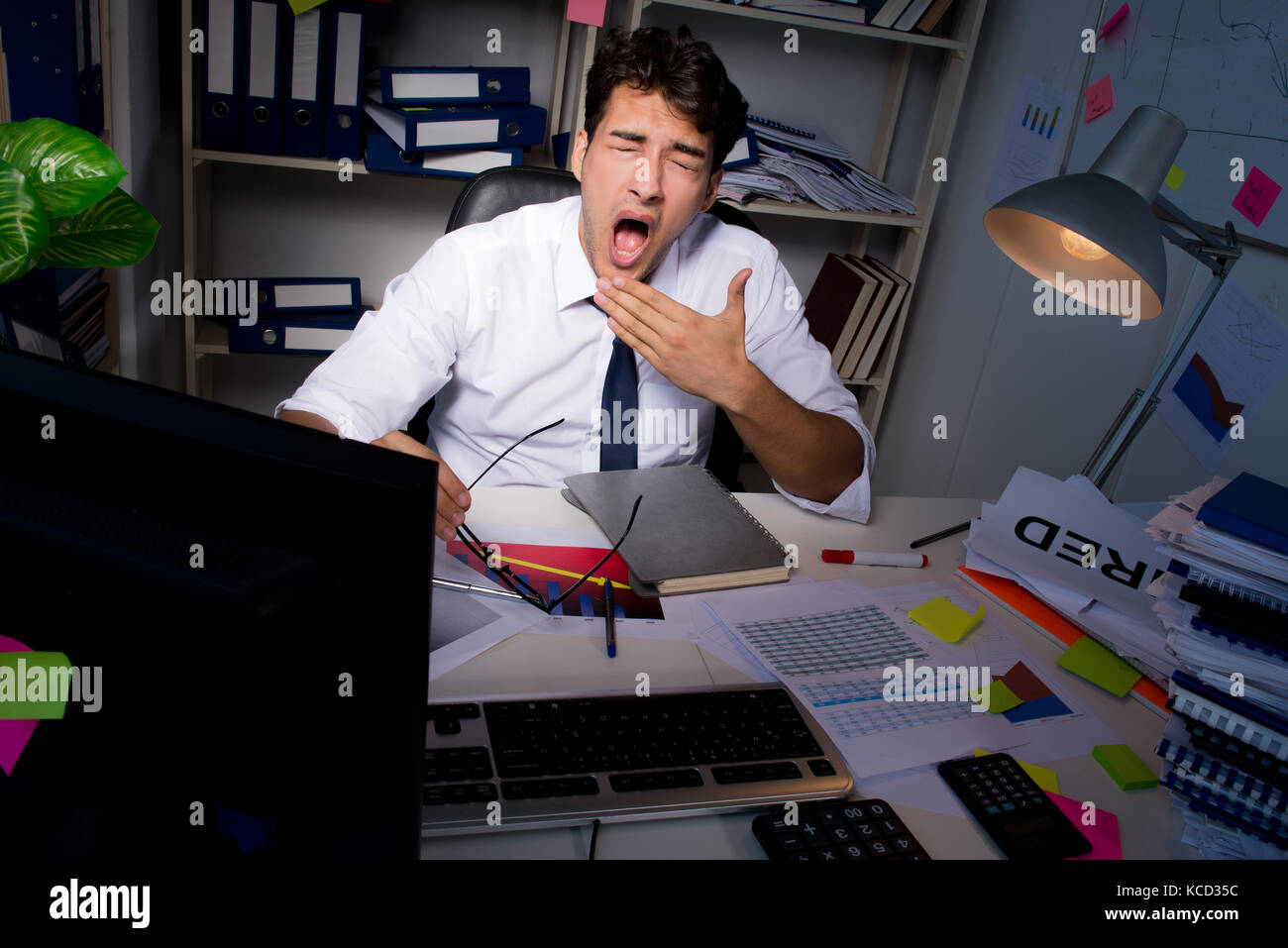 Man businessman working late hours in the office Stock Photo - Alamy