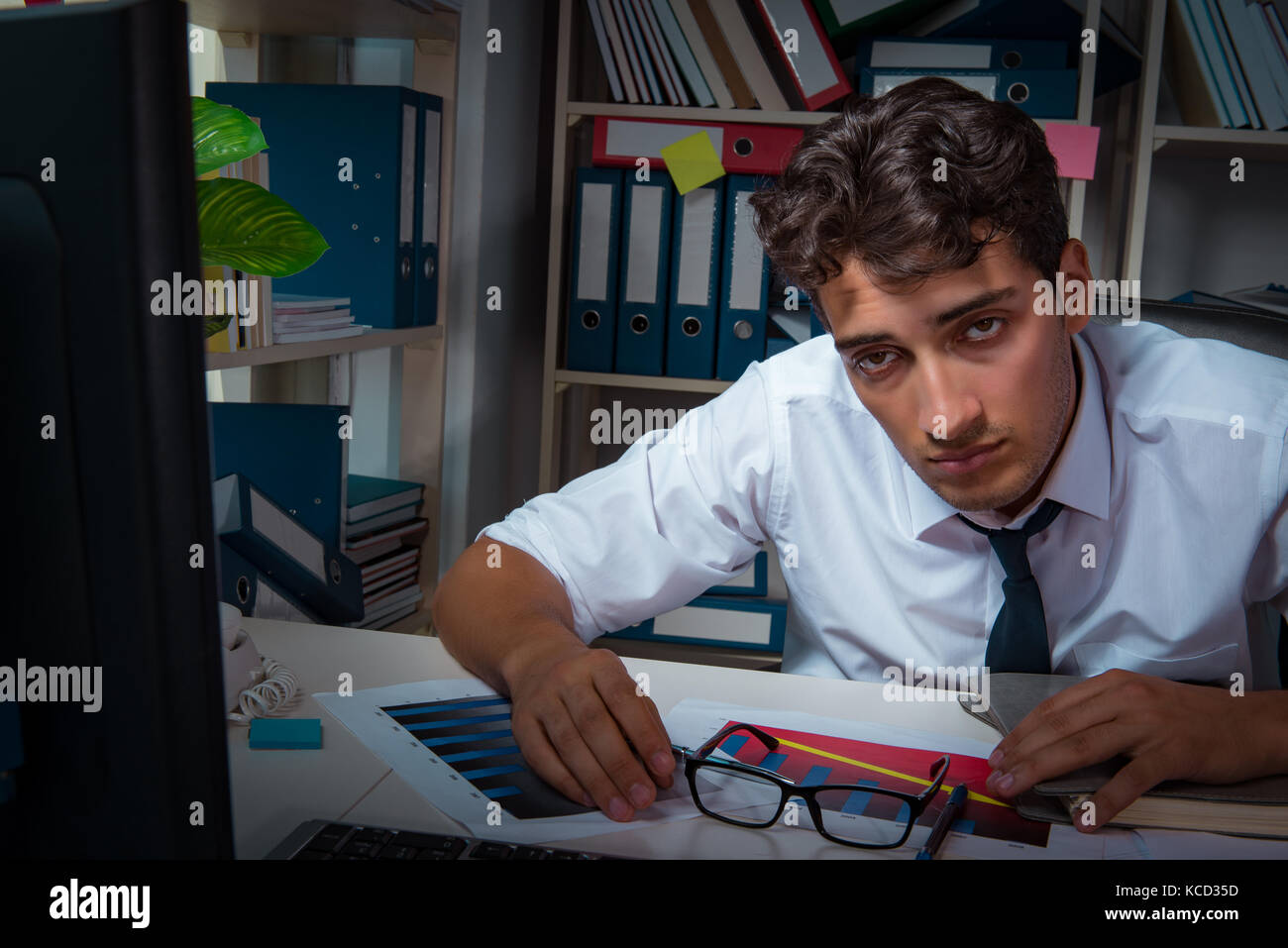 Man businessman working late hours in the office Stock Photo - Alamy