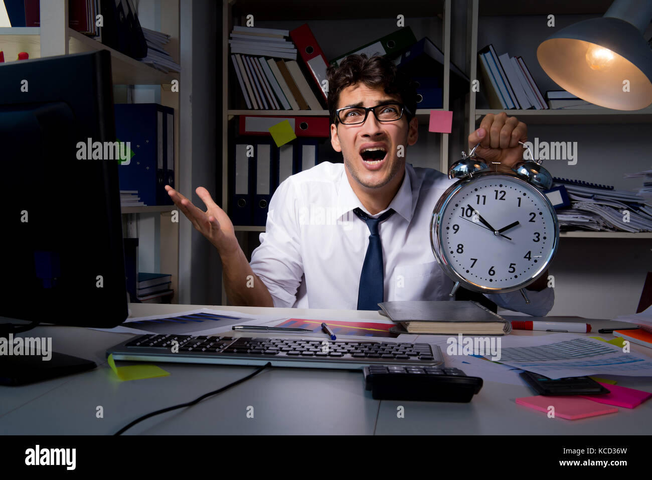 Man businessman working late hours in the office Stock Photo - Alamy