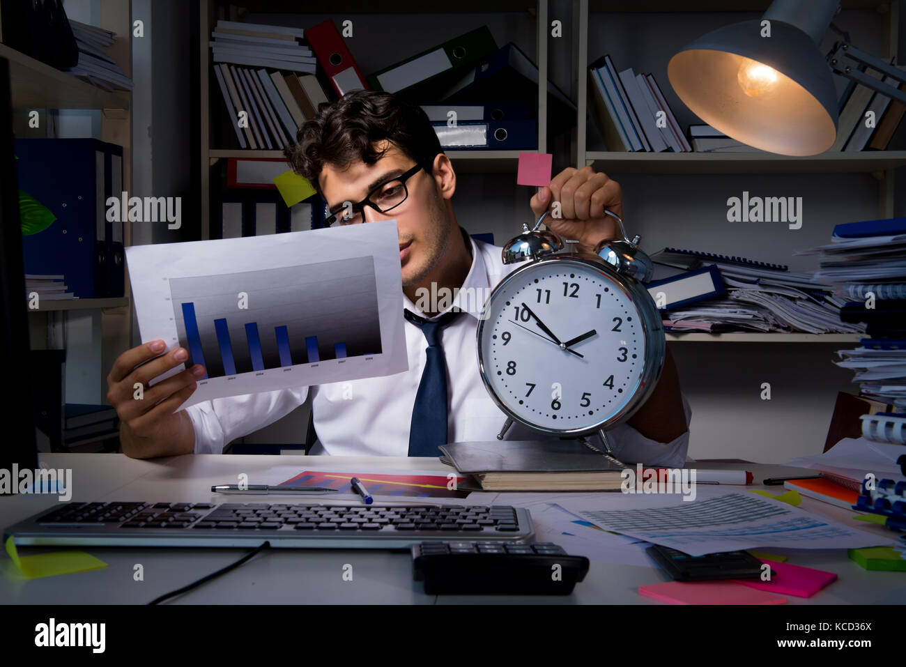 Man businessman working late hours in the office Stock Photo - Alamy