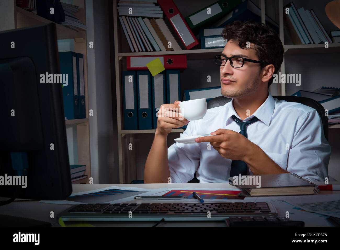 Man businessman working late hours in the office Stock Photo - Alamy