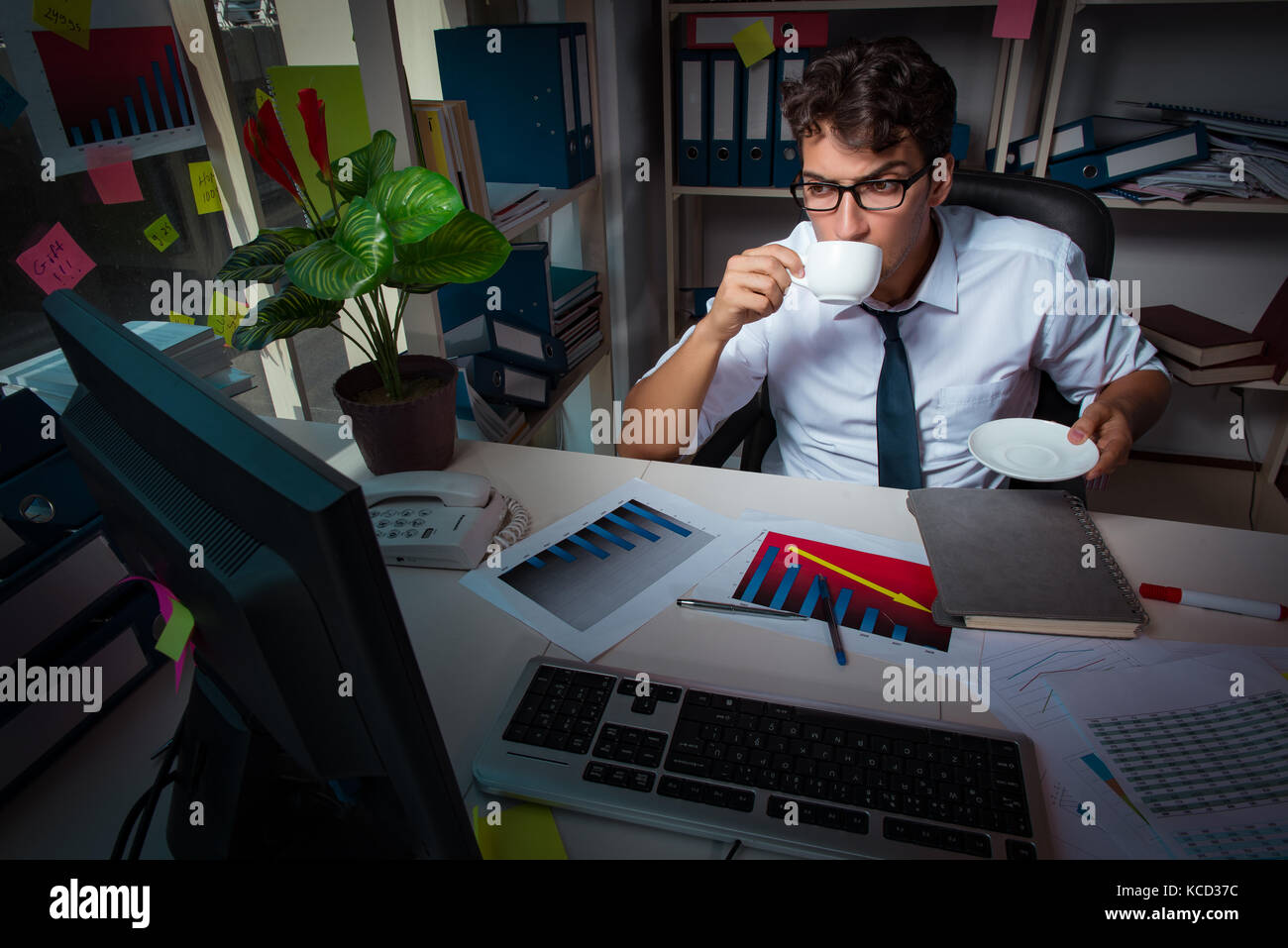 Man businessman working late hours in the office Stock Photo - Alamy