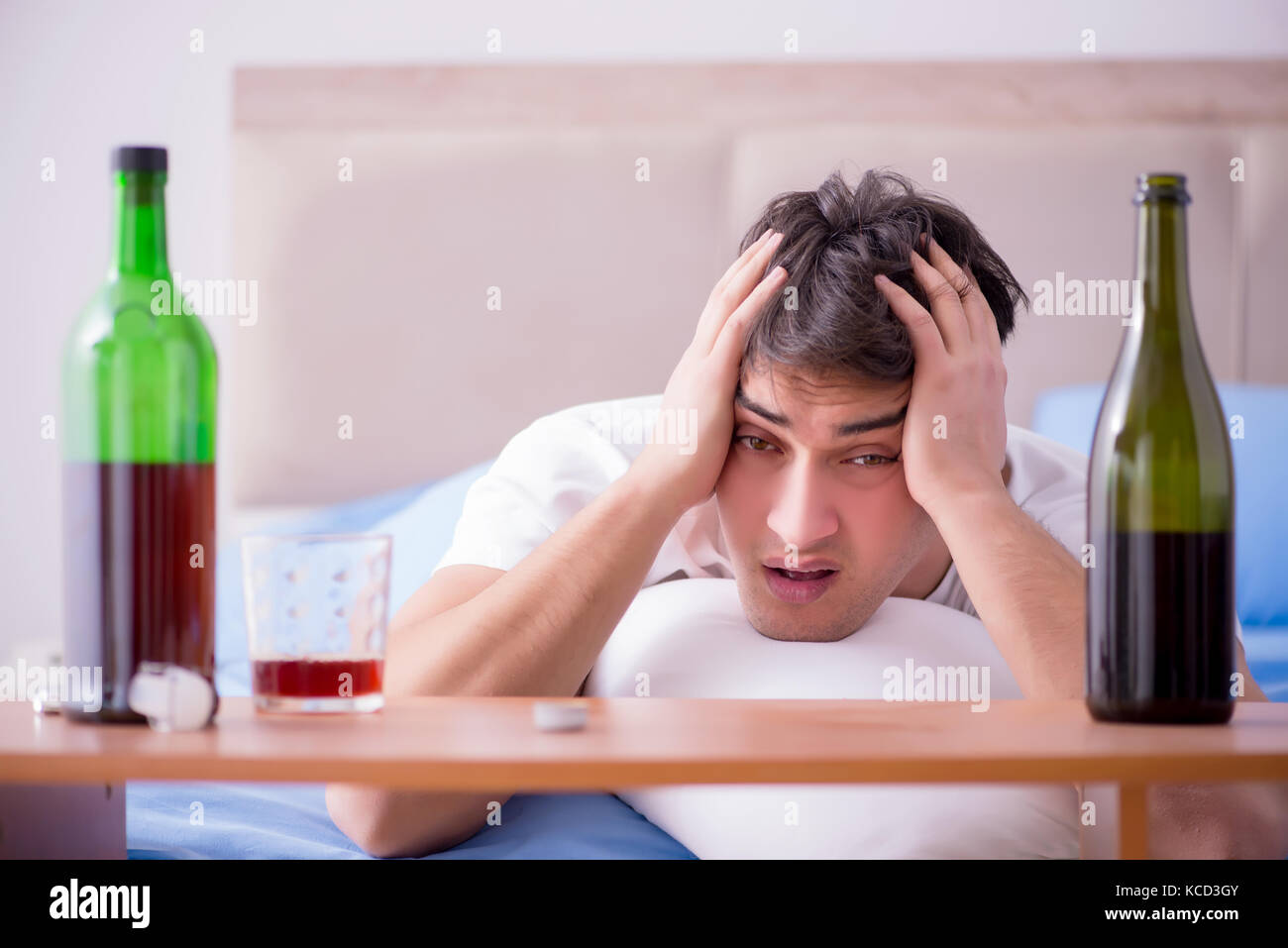 Man alcoholic drinking in bed going through break up depression Stock ...