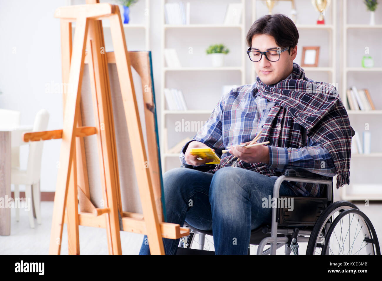 Disabled artist painting picture in studio Stock Photo - Alamy