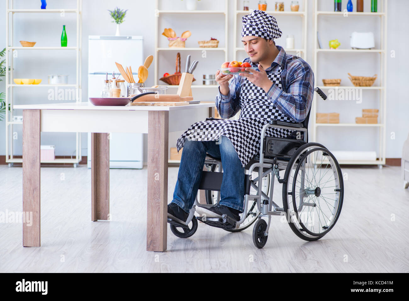 Young disabled husband preparing food salad Stock Photo - Alamy