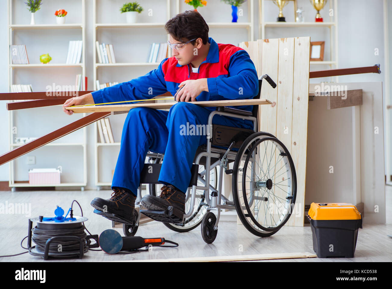 Disabled carpenter taking measurement in workshop Stock Photo - Alamy