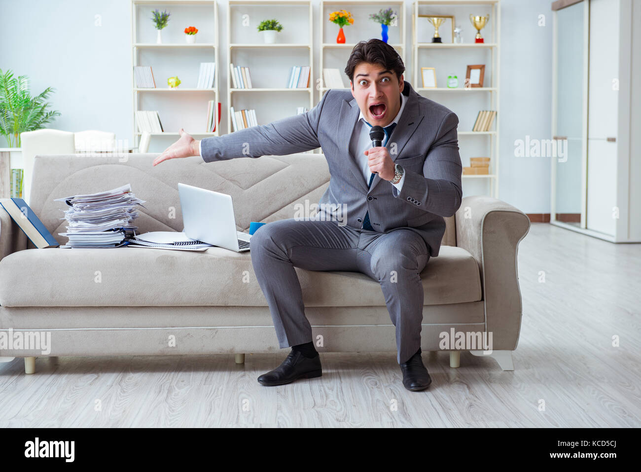 Sad businessman singing in office Stock Photo - Alamy