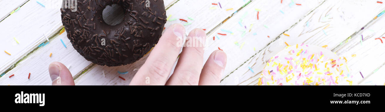 Horizontal bakground of chocolate donuts on a table Stock Photo - Alamy