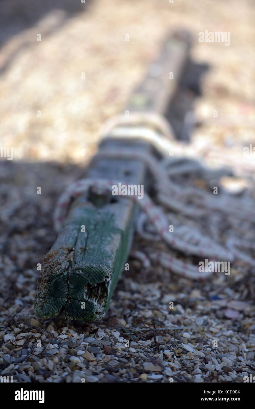 a piece of driftwood and some old weather worn ropes knotted around a ...