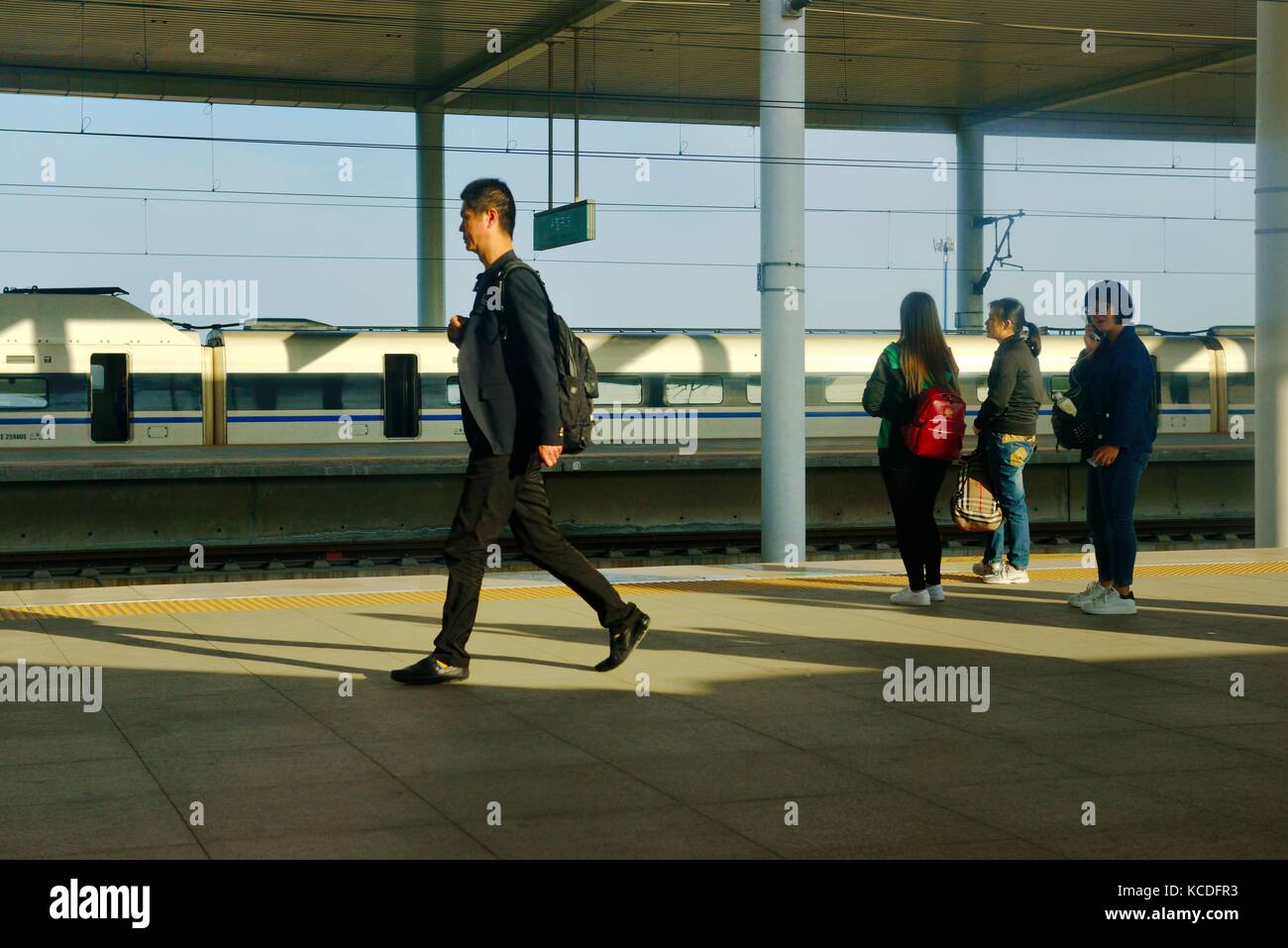 Platform, rail train and passengers on new Chinese railway station at ...