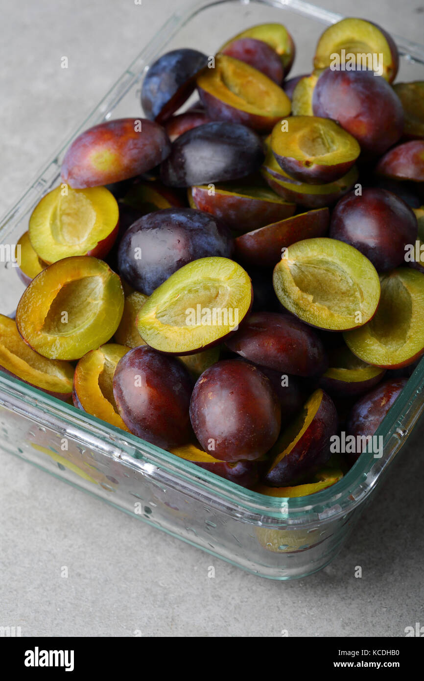 Ripe plums in container, food closeup Stock Photo - Alamy