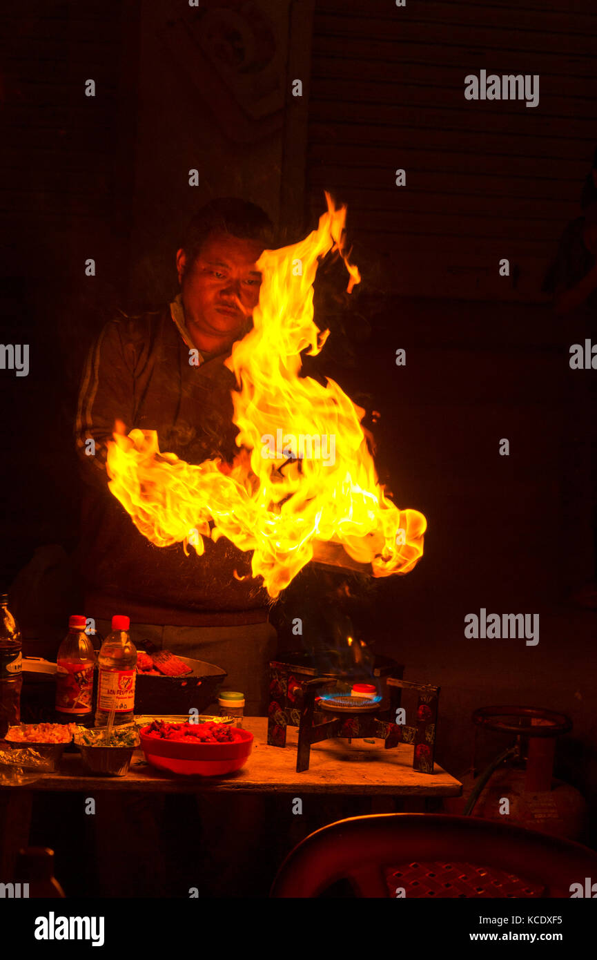 Indian Man flaming food, Night market, Kohima, Nagaland, India Stock ...