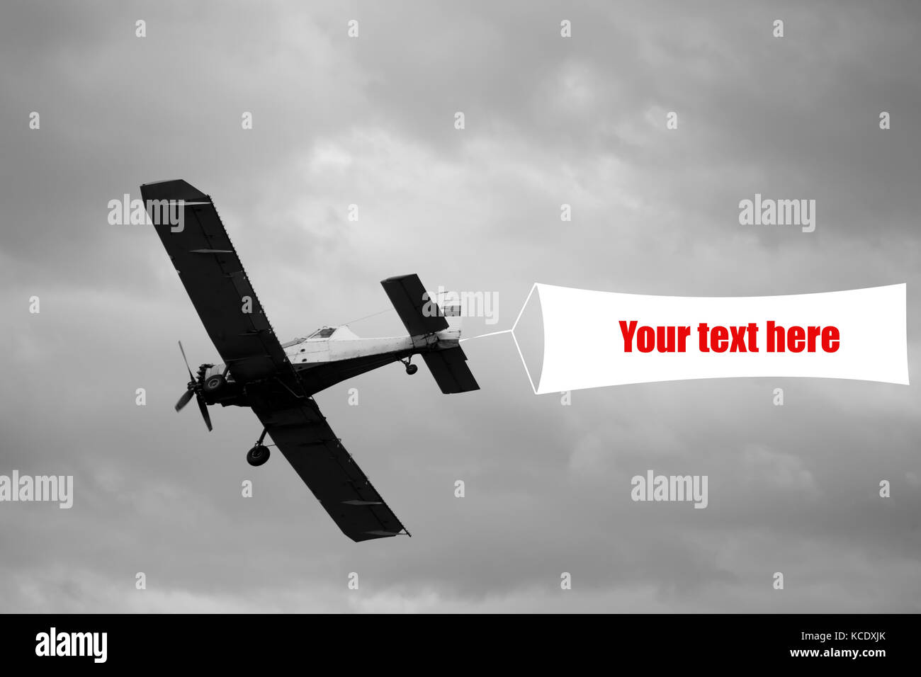 Vintage airplane fly and show advertising board on sky Stock Photo - Alamy