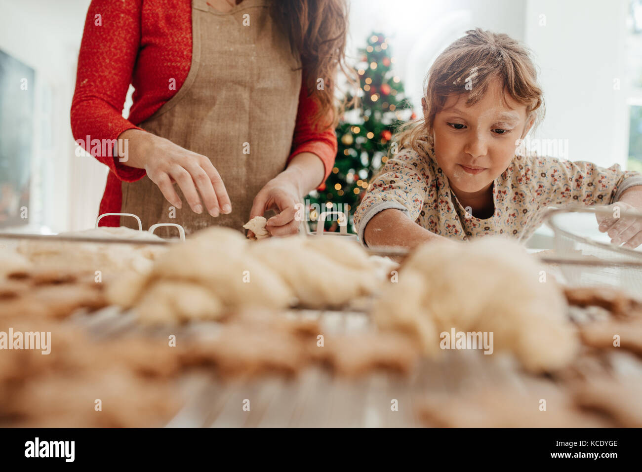 Mother and child making Christmas cookies. Blurred view of baked ...