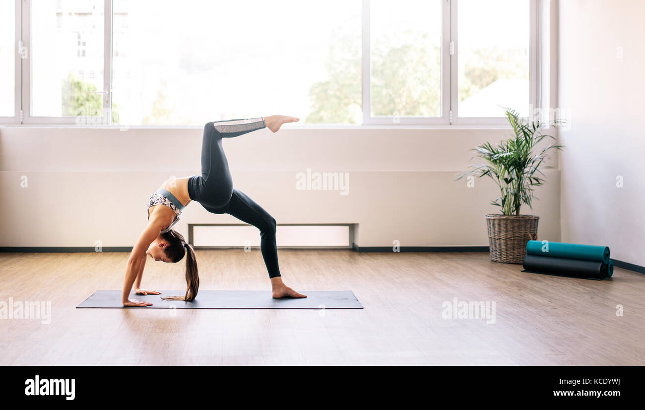 Fitness woman doing backbend stretching yoga exercise. Healthy female ...