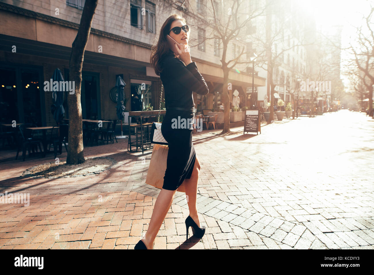 Female shopper walking with bags hi-res stock photography and images ...