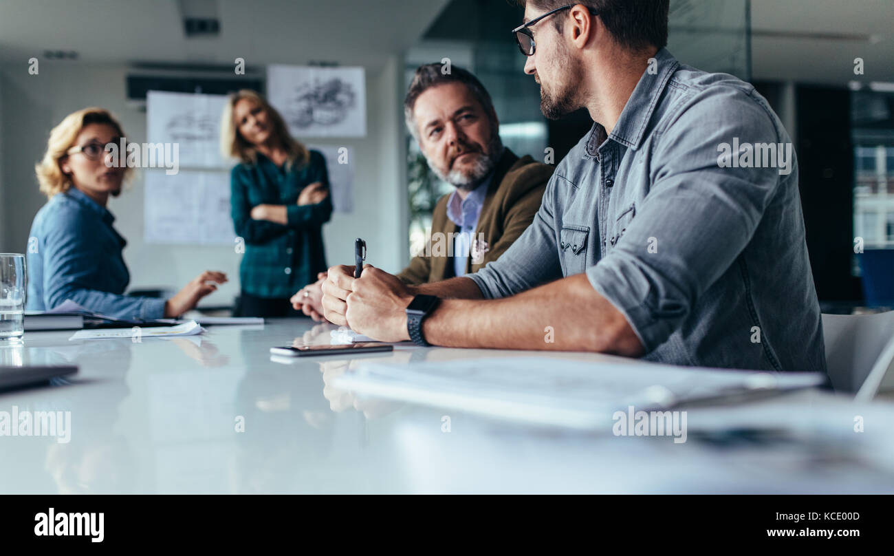 Businessman explaining new business ideas to peers. Business people ...