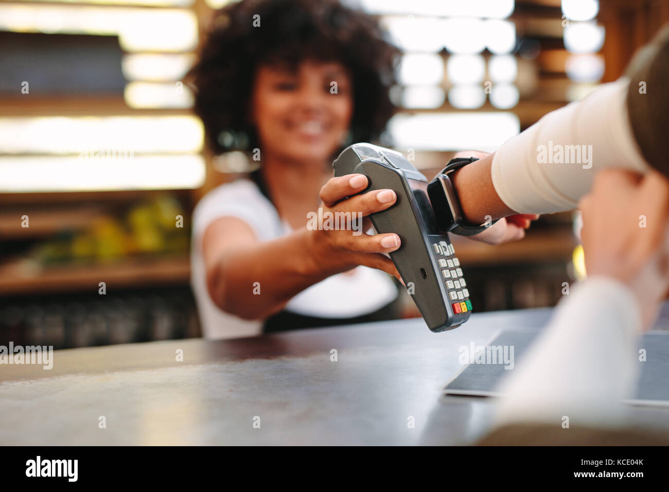 Customer making wireless or contactless payment using smartwatch ...