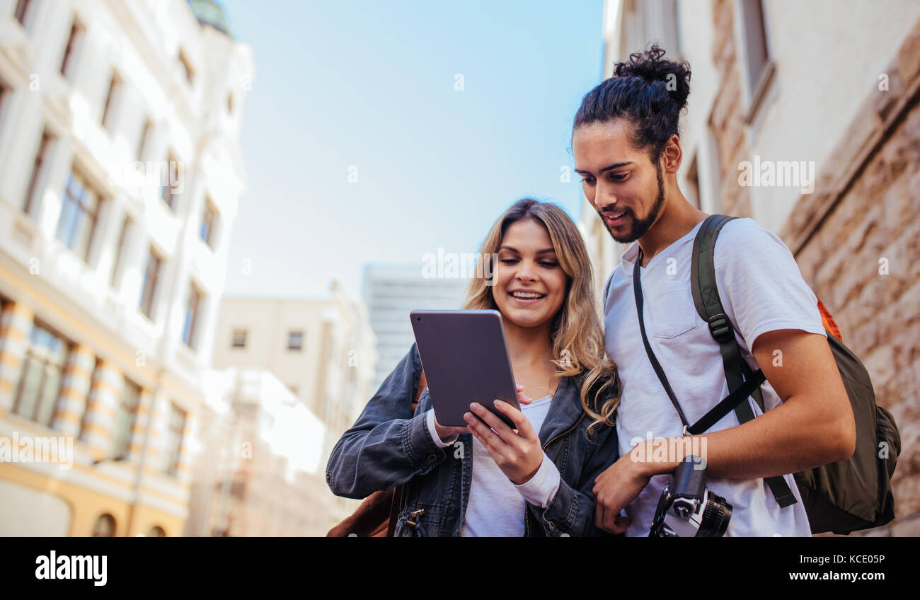 Tourists using navigation tools to explore the city. Man and woman ...