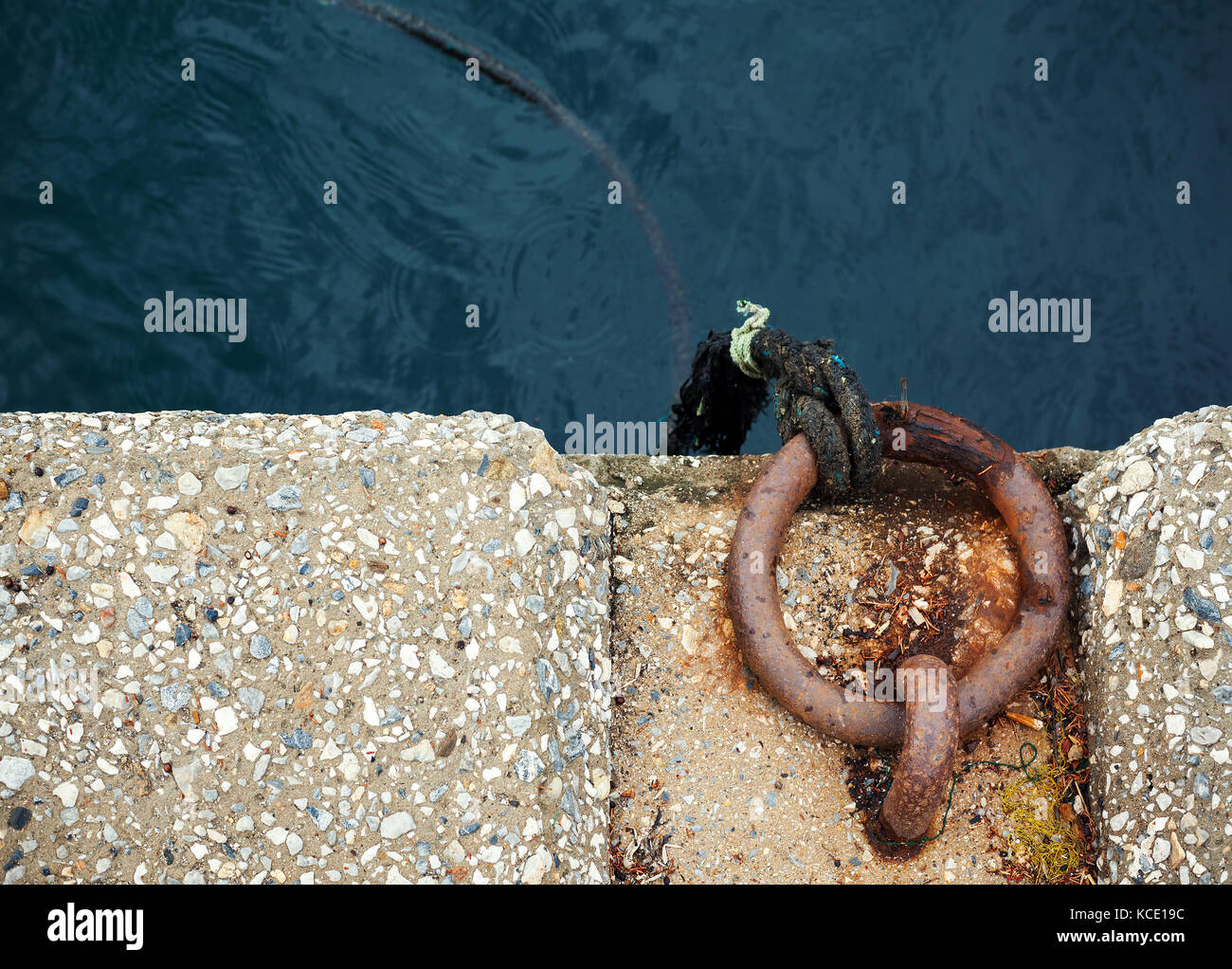 One old metal ring and rope for bounding the boat Stock Photo - Alamy