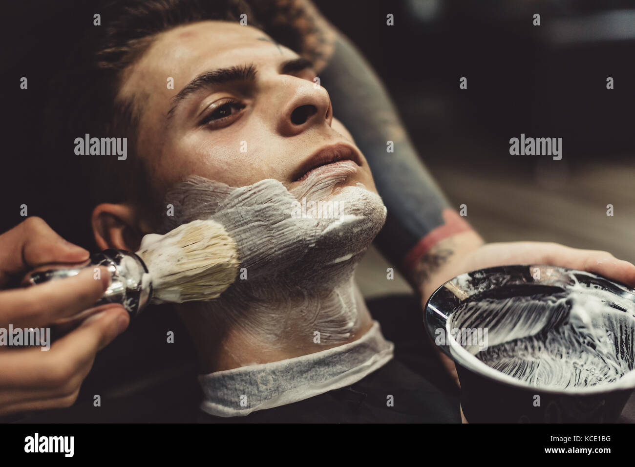 Barber shaving client Stock Photo - Alamy