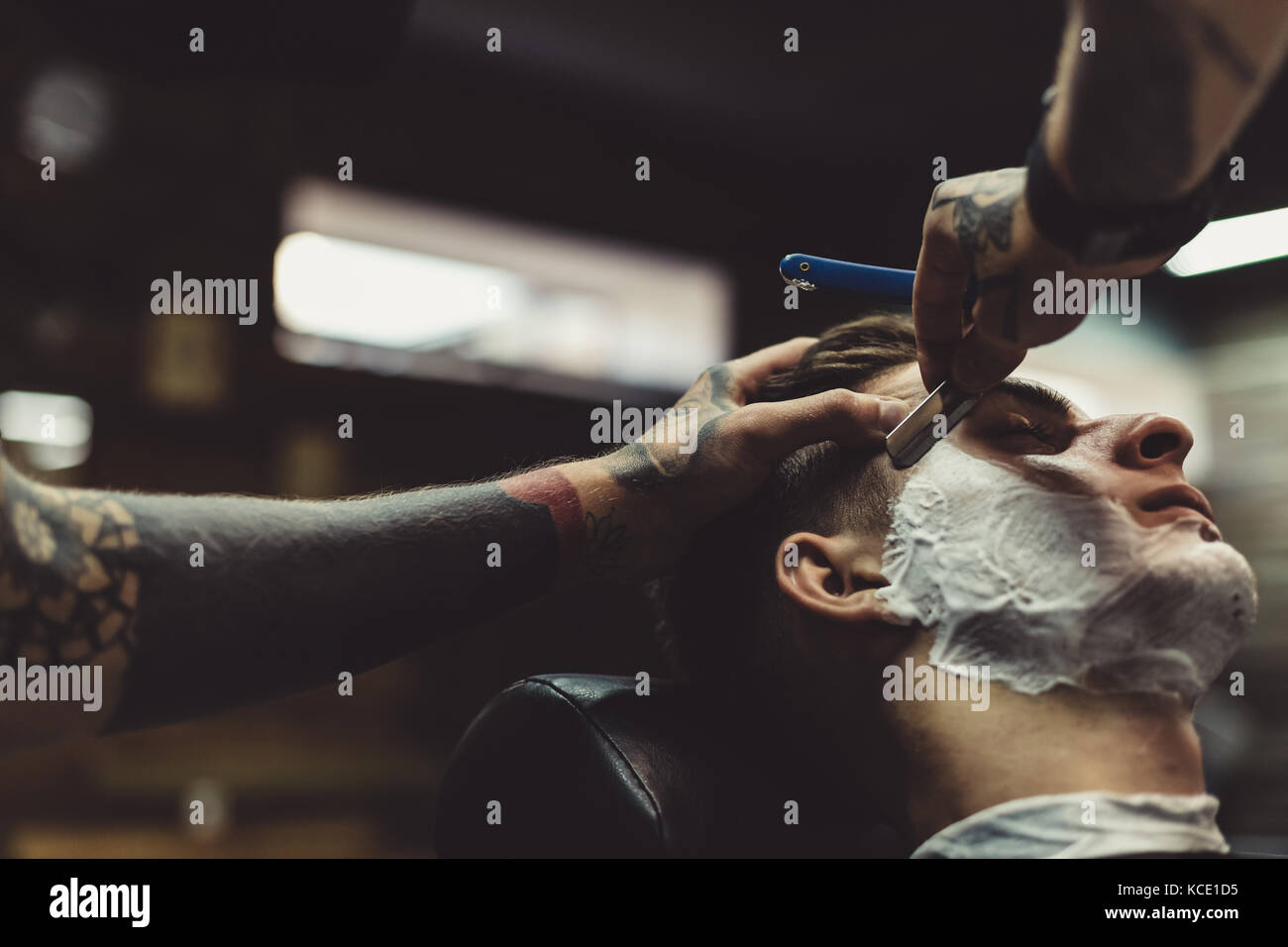 Barber shaving client Stock Photo - Alamy